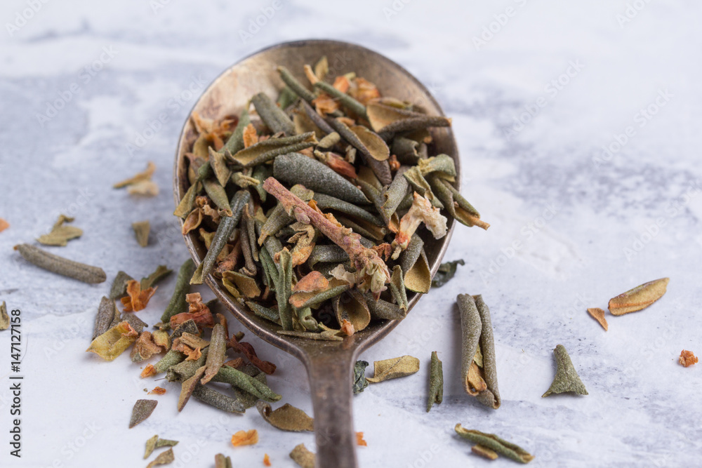 Rhododendron of Adamsia in a spoon on a white background. Dry medicinal ...
