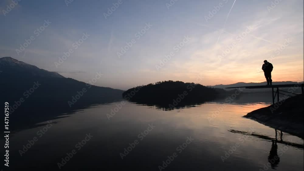 A man catches a fish. Happy relaxed hours alone with nature. Landscape ...