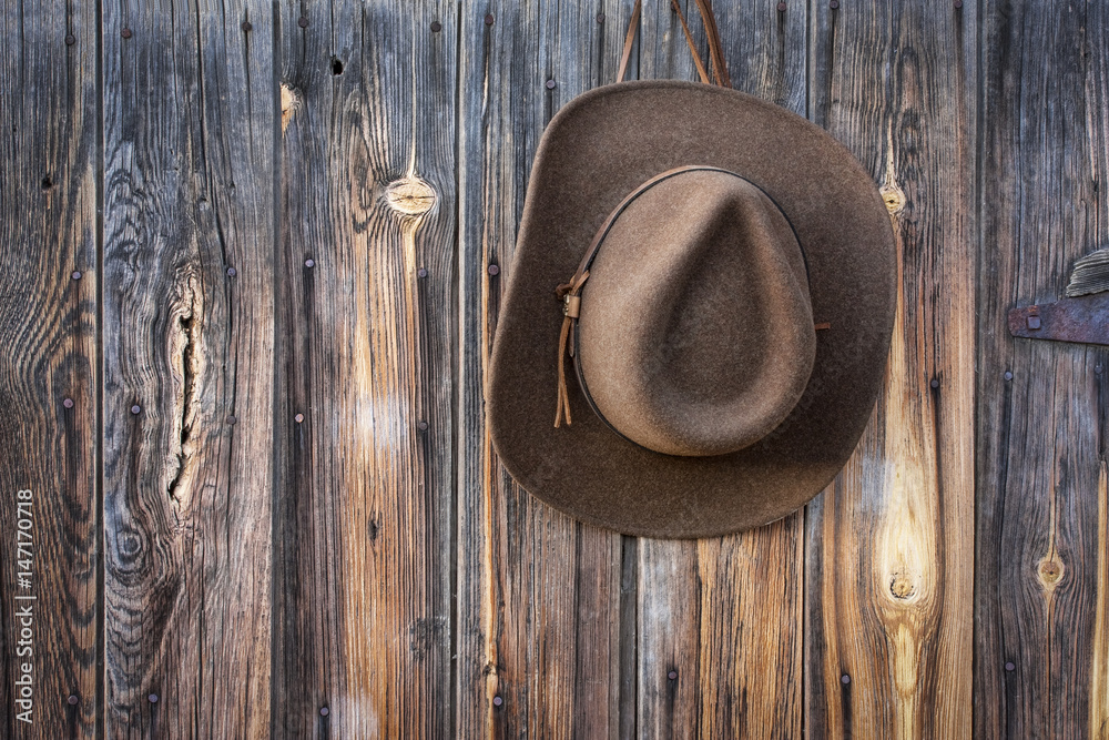 felt cowboy hat hanging on barn wall Stock Photo | Adobe Stock