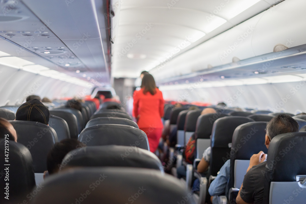 passenger seat, Interior of airplane with passengers sitting on seats ...