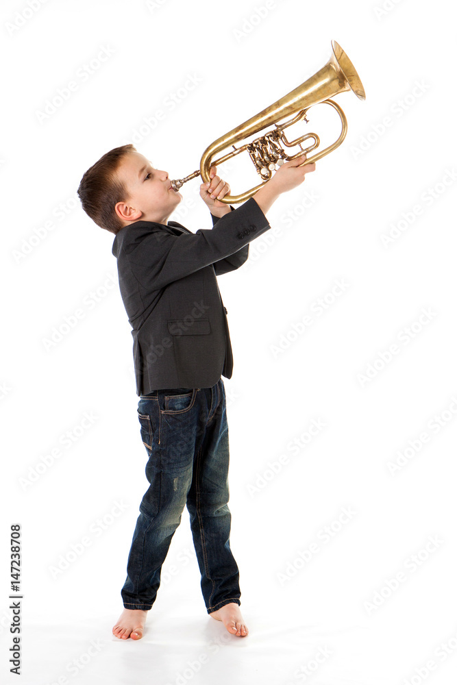 young boy blowing into a trumpet against white background Stock Photo ...