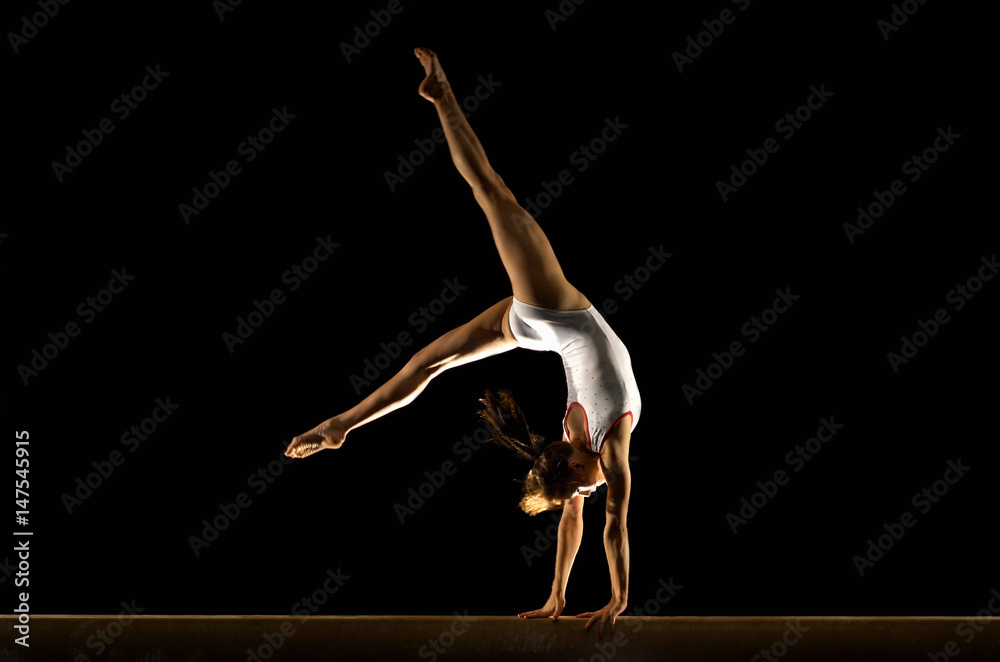 gymnast doing hand stand on beam Stock Photo | Adobe Stock
