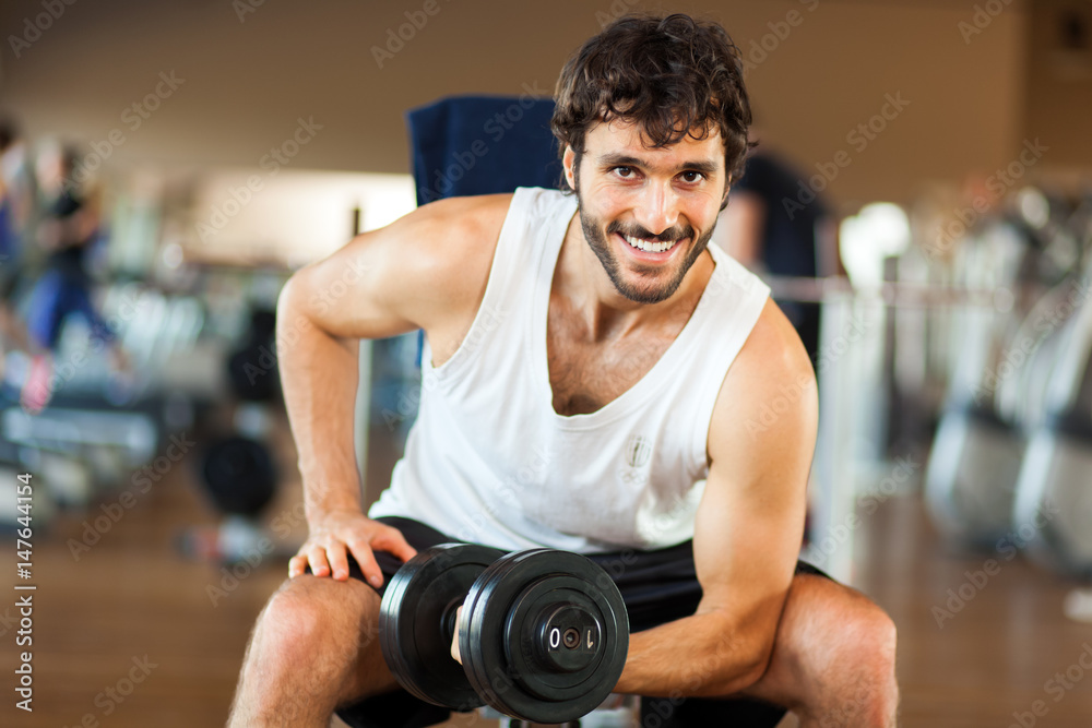 Bodybuilder using a dumbbell to work out Stock Photo | Adobe Stock