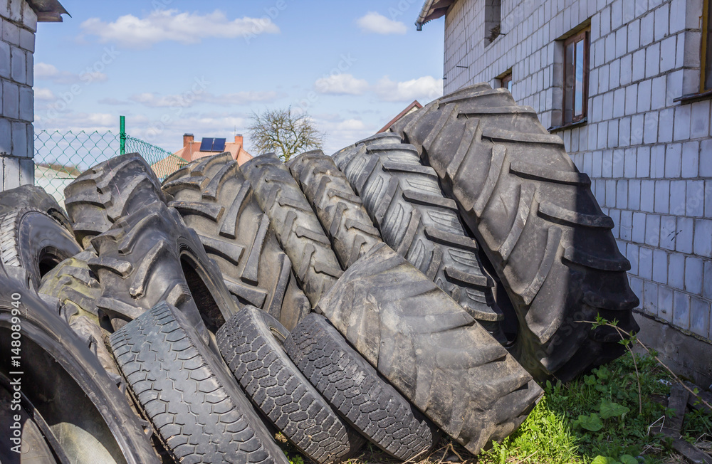 Old rubber tires from combine harvesters . Dairy farm in Podlasie ...