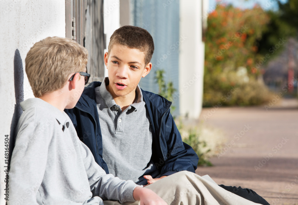 Young teen males talking to friend outside Stock Photo | Adobe Stock