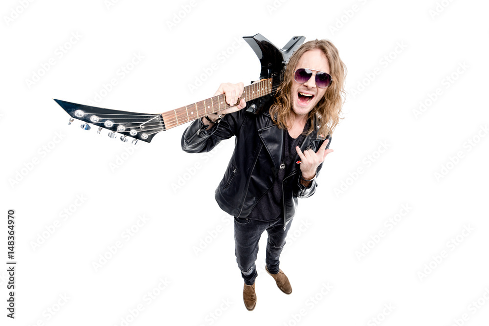 handsome rocker in sunglasses with electric guitar showing rock sign ...
