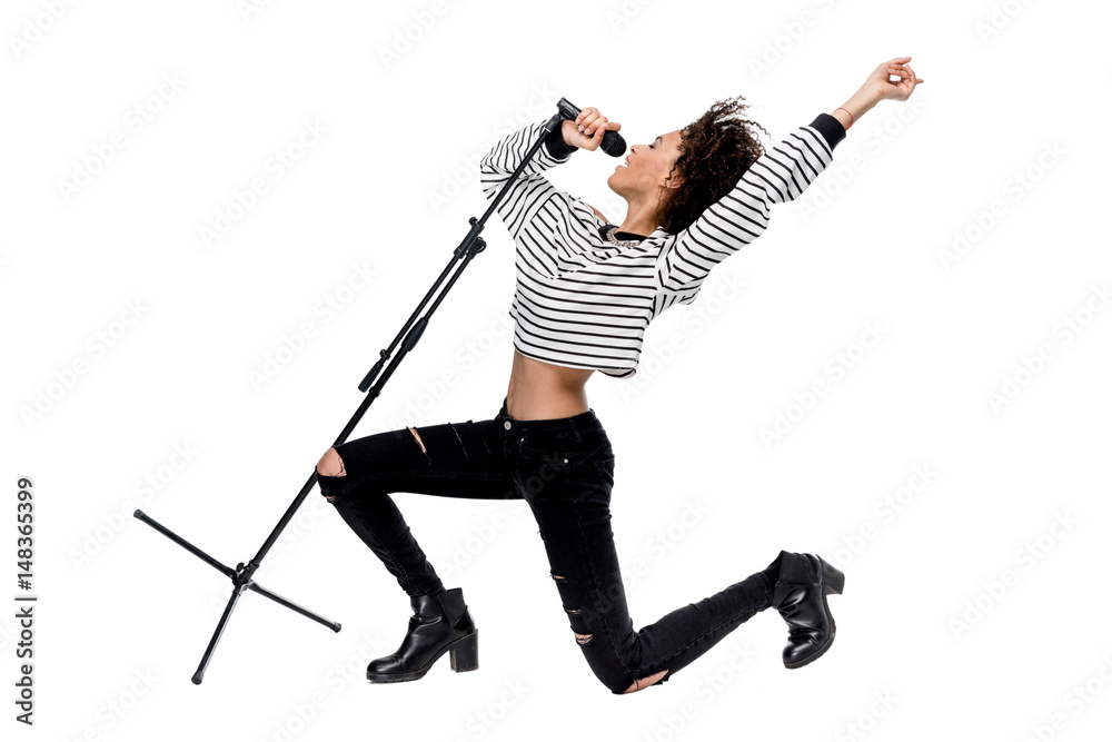 Beautiful young emotional heavy metal singer with microphone singing ...