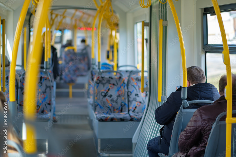 Interior of modern city articulated low floor tram with seats, yellow ...