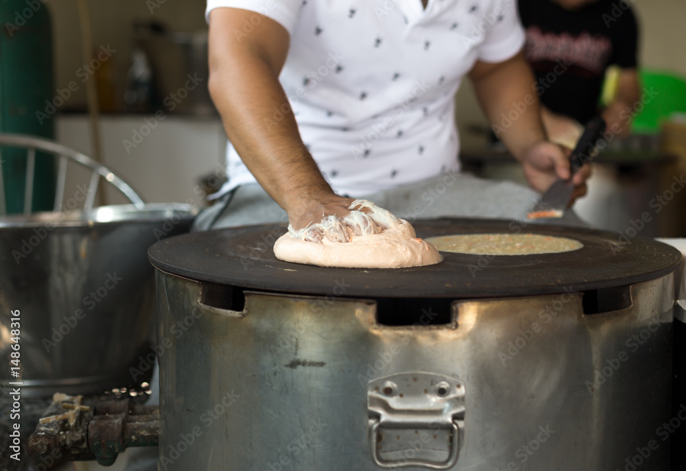 Man making a Roti dough sheet Stock Photo | Adobe Stock