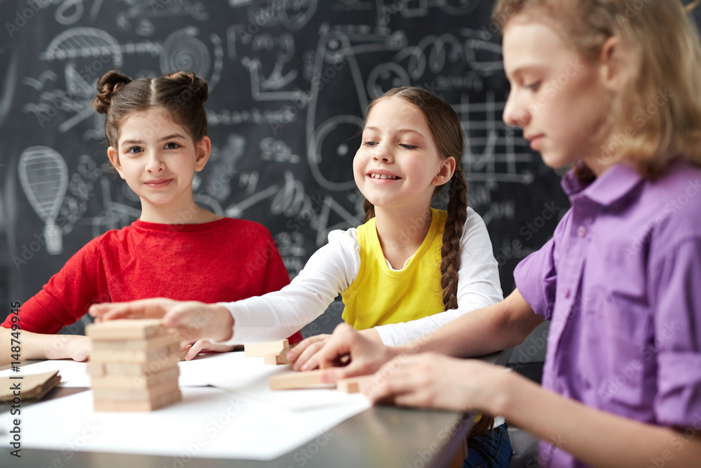 Group of kids playing jenga wooden bricks at school Stock Photo | Adobe ...