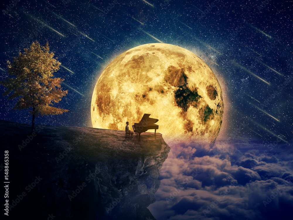 Night scene with a boy, musician standing at the edge of a cliff chasm ...