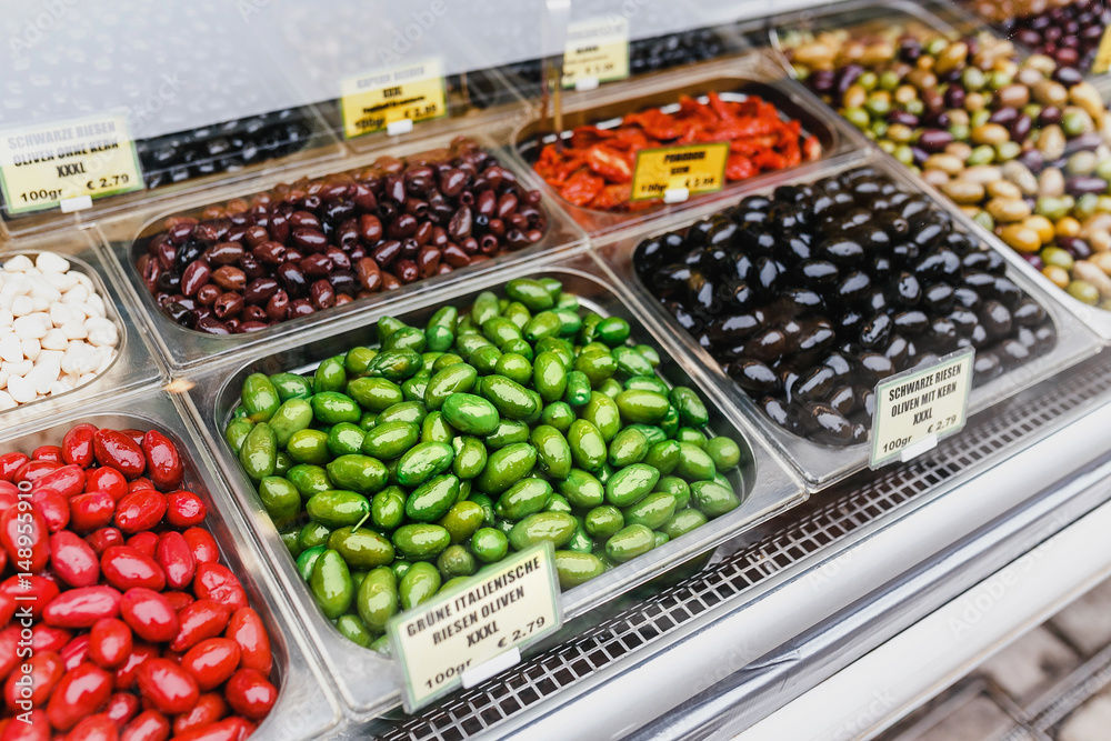 Bowls of various olives for sale at a open street market with price ...