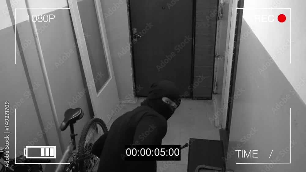 surveillance camera caught the robber in a mask running off with a bag ...