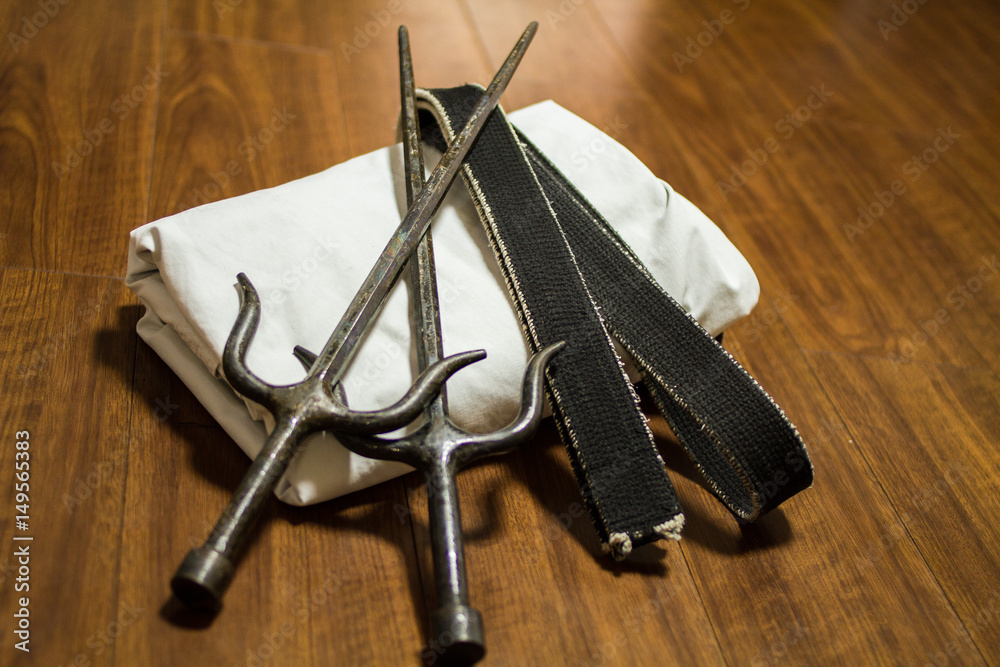 Sai ( traditional okinawan karate's weapon) , black belt and Gi ...