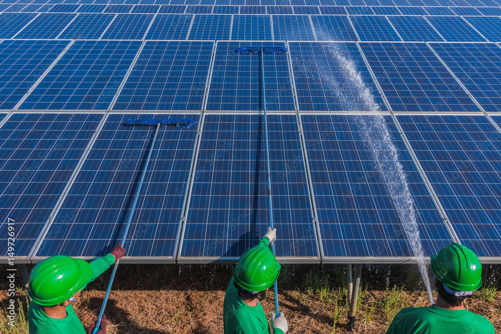 labor working on cleaning solar panel at solar power plant Stock Photo ...