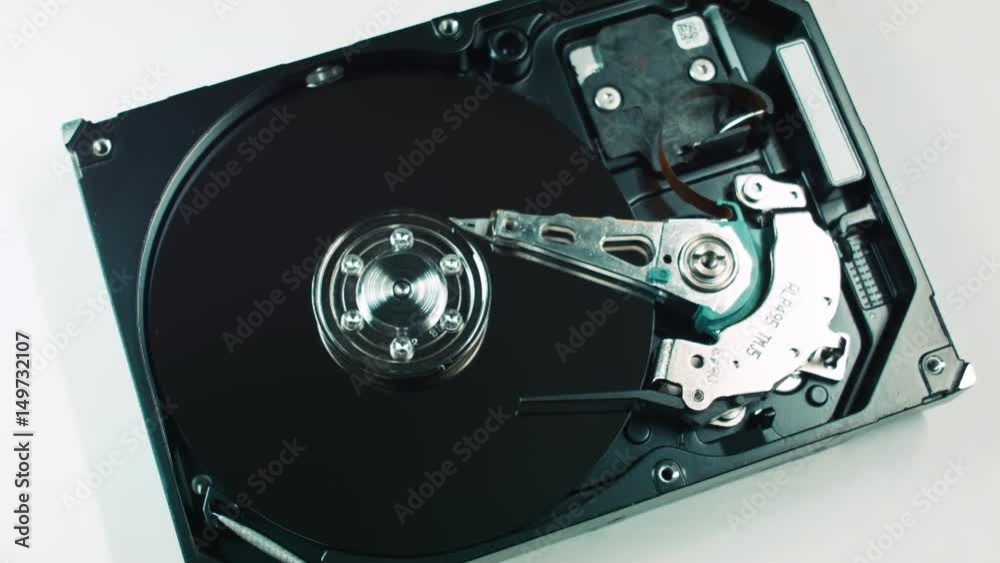 Hard drive, computer technology. Dismantled HDD. Head reading data from ...