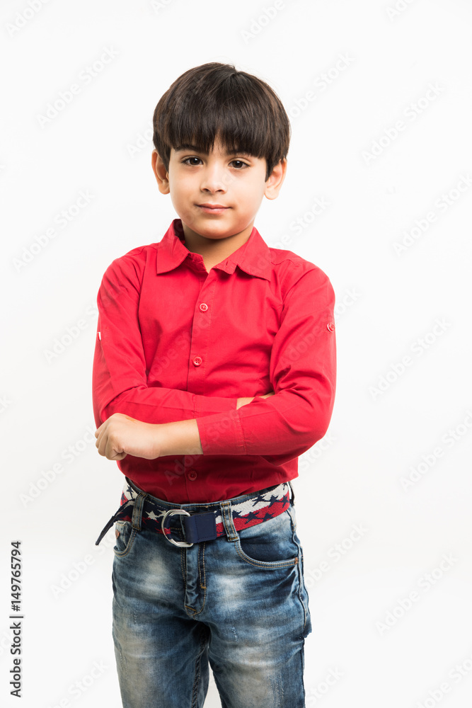 indian cute little kid or small boy standing over white background with ...