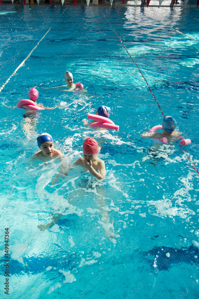 happy children kids group at swimming pool class learning to swim Stock ...