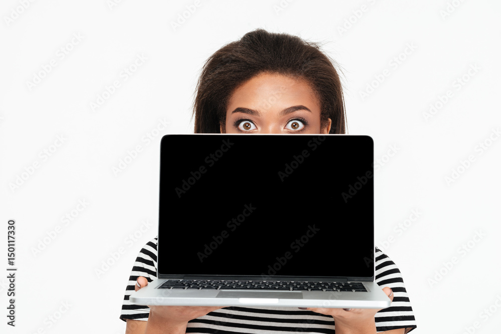 Surprised shocked african woman hiding behind blank screen laptop Stock ...