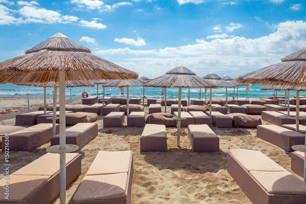 Sunbeds with umbrellas on white sand beach in Villasimius beach ...
