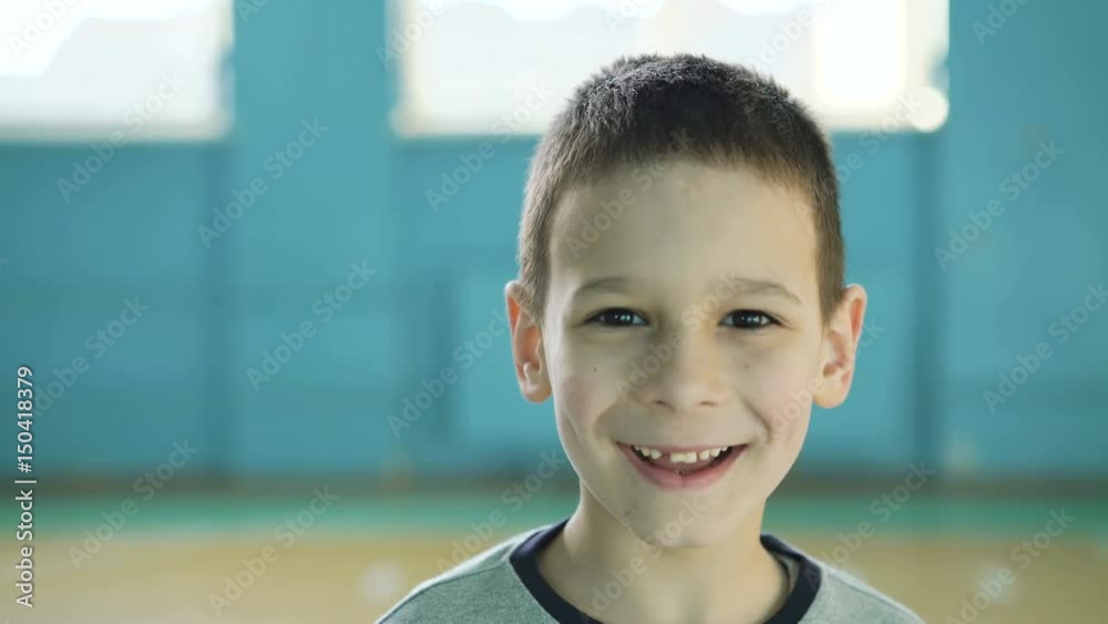 Funny handsome boy looking back and laughing at camera in the gym 4K ...