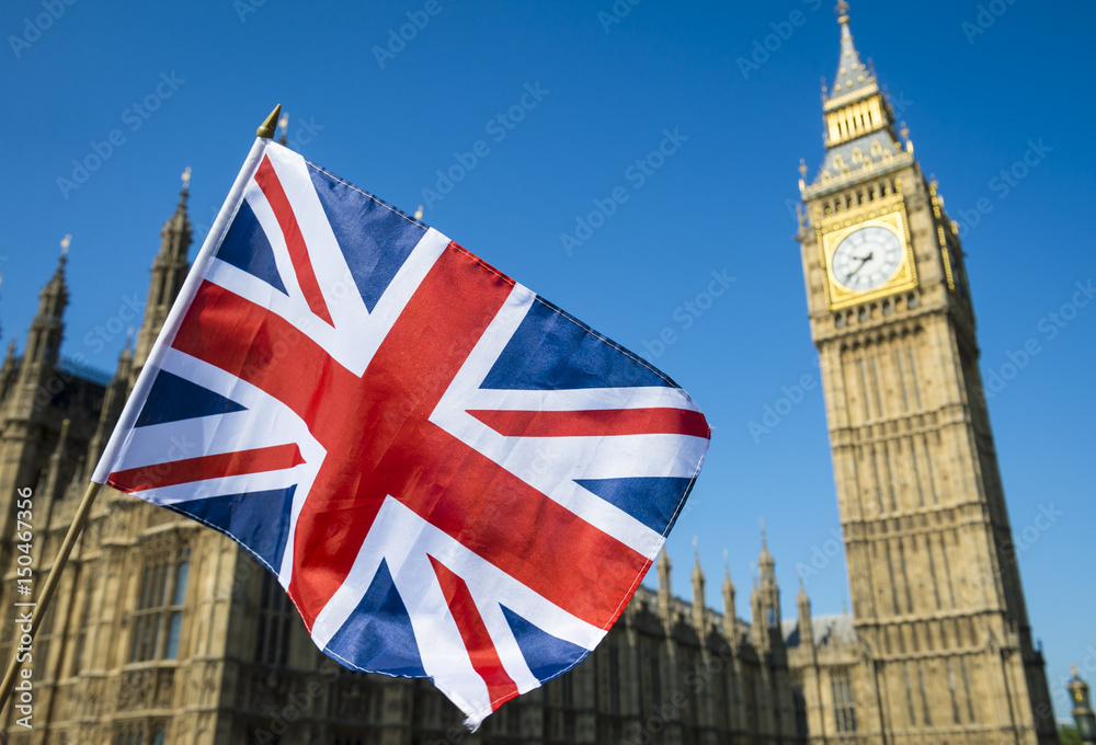 Bright view of United Kingdom flag flying in front of the Houses of ...