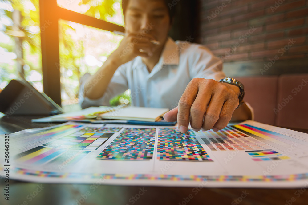 designer man working graphic with color chart and write short note for ...