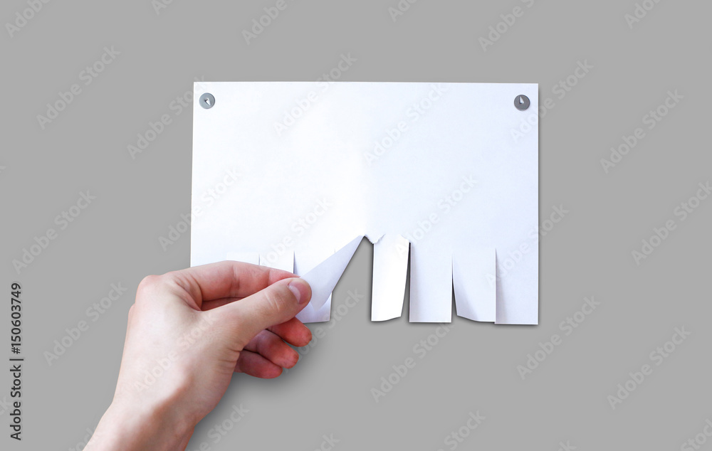 Hand pulls a piece of paper. Empty paper ad loose leaves isolated on a ...