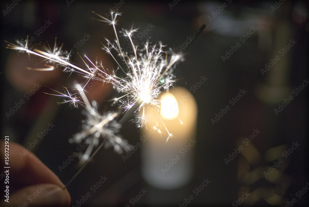 Hand holding a lit sparkler Stock Photo | Adobe Stock