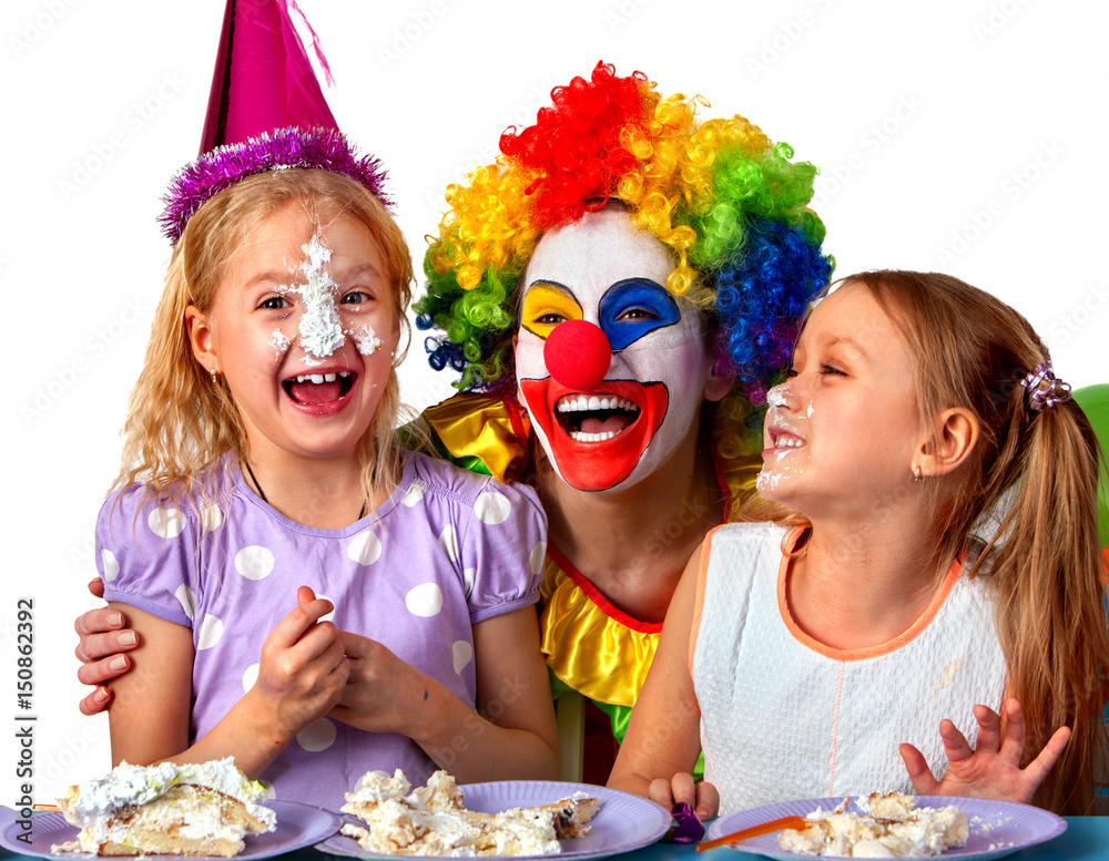 Birthday children clown eating cake with two girl together. Kids with ...