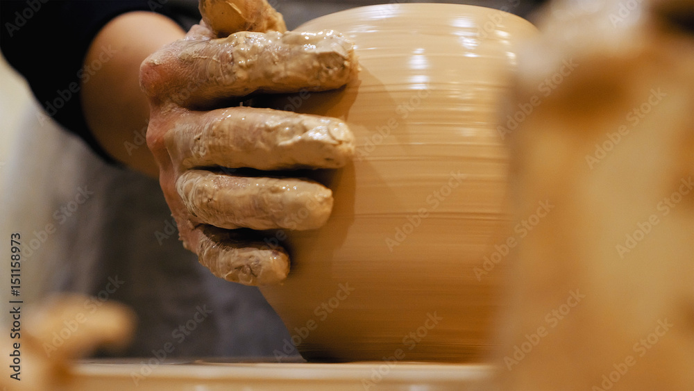Potter is making clay pot bowl or vase ceramics porcelain on the potter ...