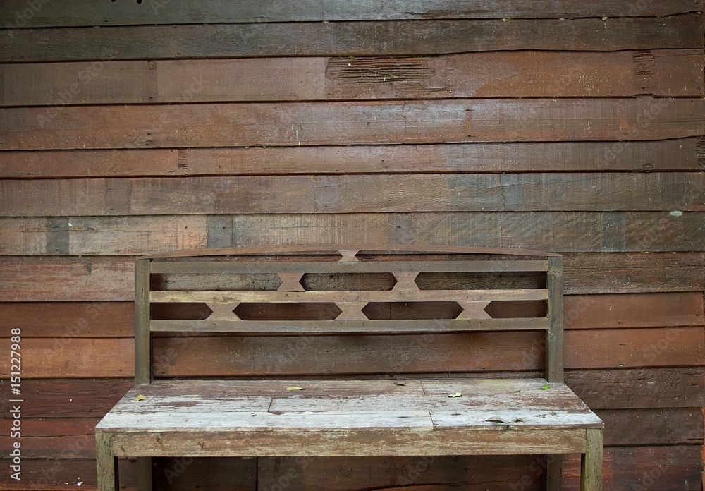 Old wooden bench with brown planks wall as background,Texture for add ...