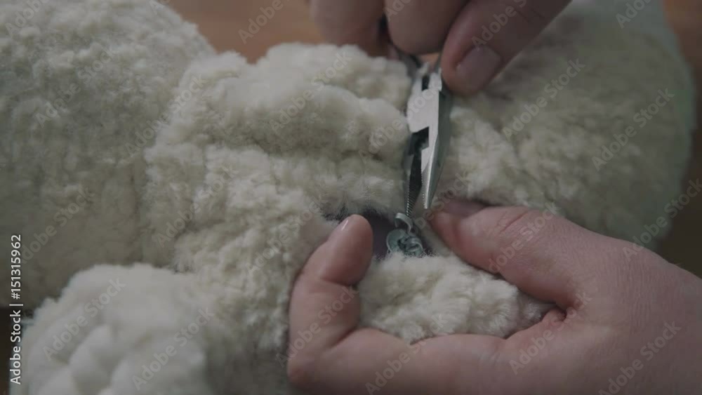 Stitching the details of a plush toy. Repair of plush toys: women's ...