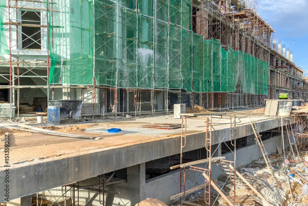 Close-up office and residential building under construction with safety ...