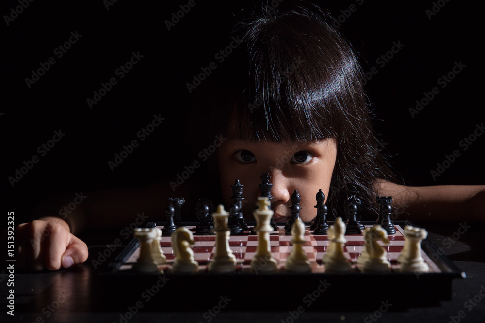 Asian Little Chinese girl playing chess Stock Photo | Adobe Stock