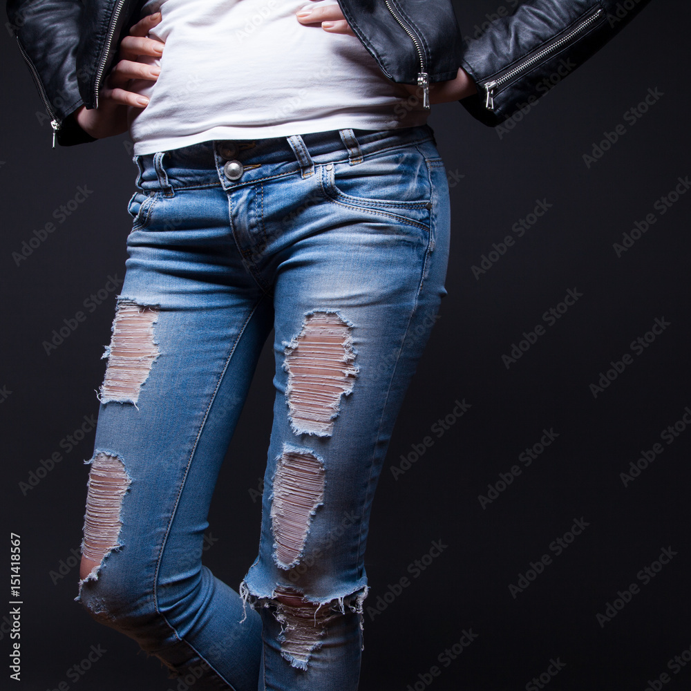 Women's legs in ragged jeans on a black background Stock Photo | Adobe ...