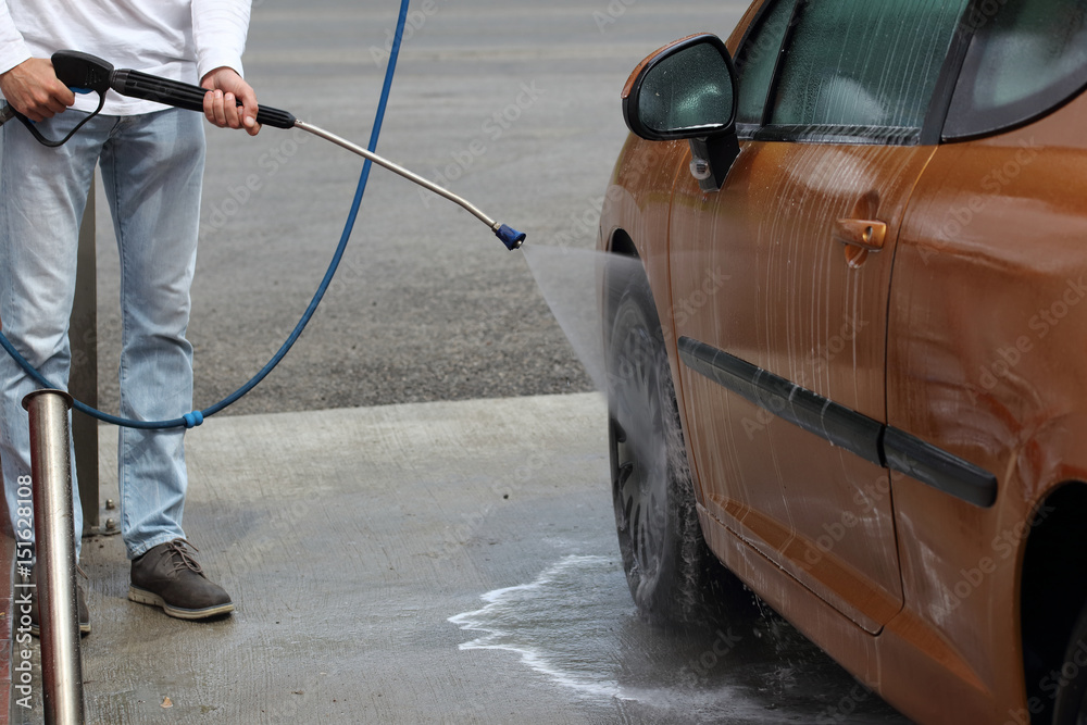 Car washing flowing water. Outdoor Self Service Cleaning Car Using High ...