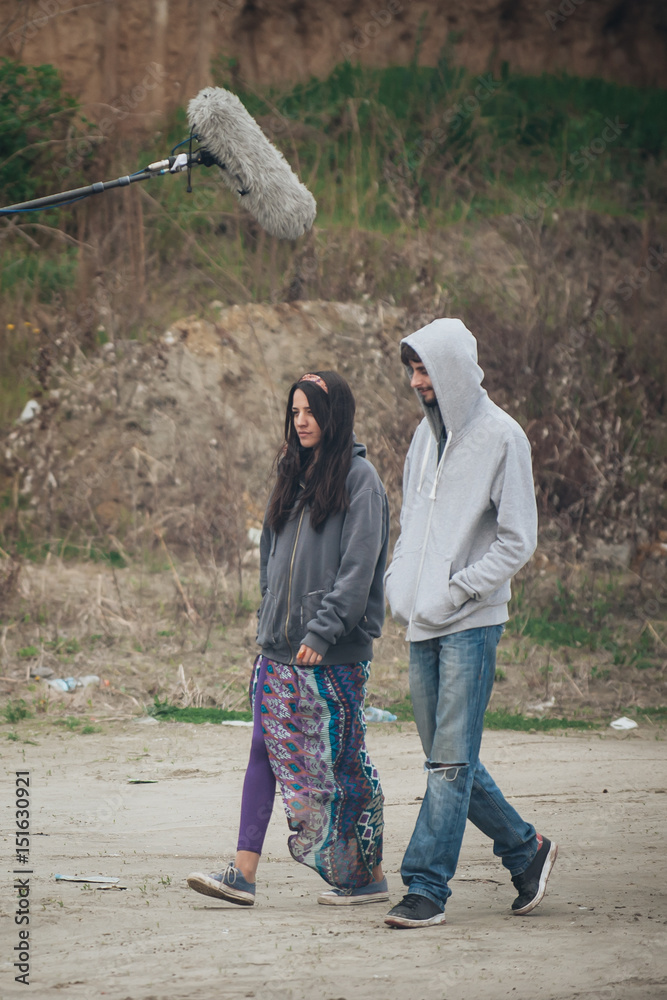 Behind scene. Actor and actress in front of boom microphone Stock Photo ...