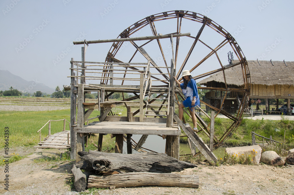 Thai women people travel and posing with big wooden turbine baler water ...