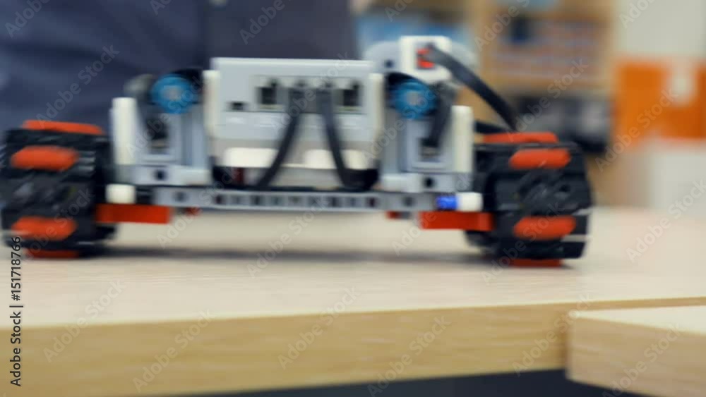 The close-up. The boy giving commands to the caterpillar robot. 4K ...