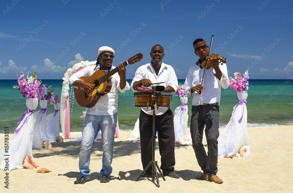 Fiddler, guitarist and drummer in white shirt and grey hat are playing ...