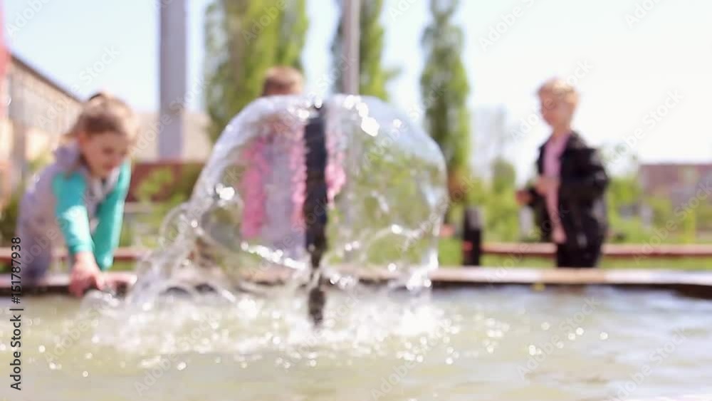Children playing with water in park fountain. Hot summer. Happy ...
