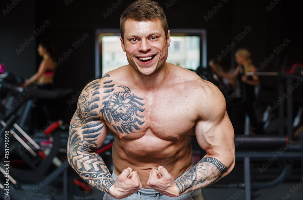 Strong bodybuilder with six pack, perfect abs, shoulders, biceps ...