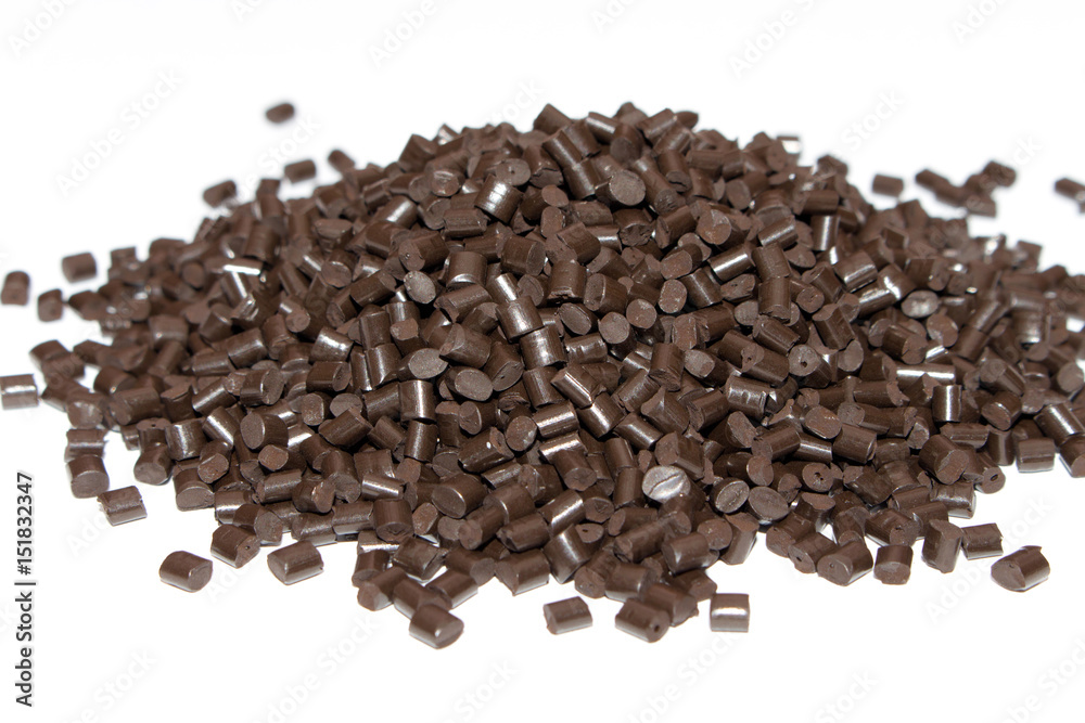 Plastic pellets brown on white background. Polymeric yellow dye ...