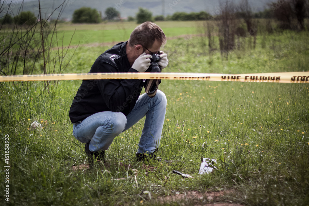 The crime scene, murder, investigation, bloody knife on the grass, an ...