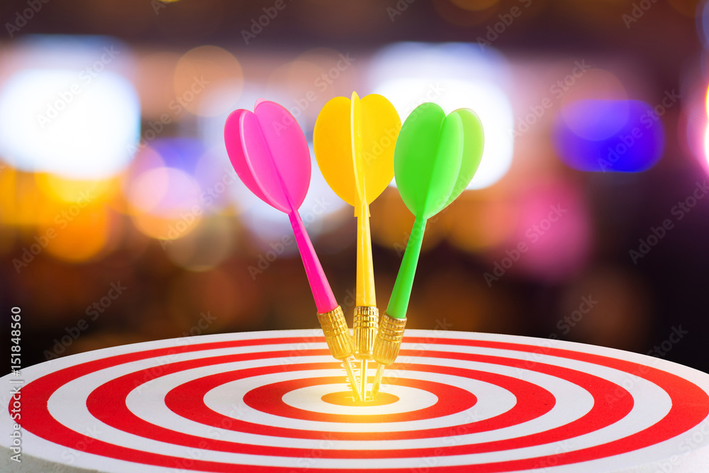 Circular target marked with numbers and dart with defocused or blurred ...