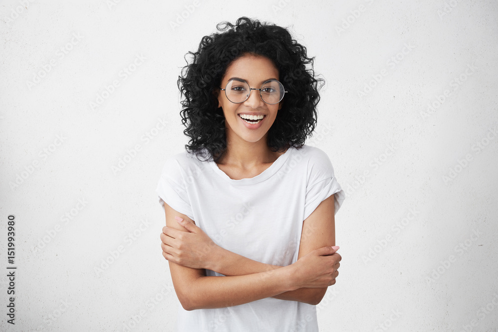 Pretty woman in white t-shirt and round eyeglasses feeling shy and a ...