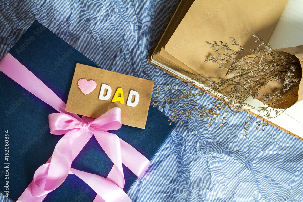 The Dark blue gift box with pink ribbon decoration and Love Dad message ...