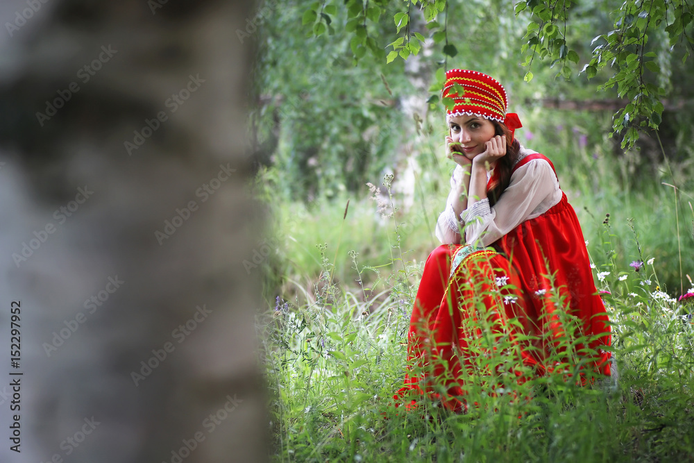 Slav in traditional dress is sitting in nature Stock Photo | Adobe Stock