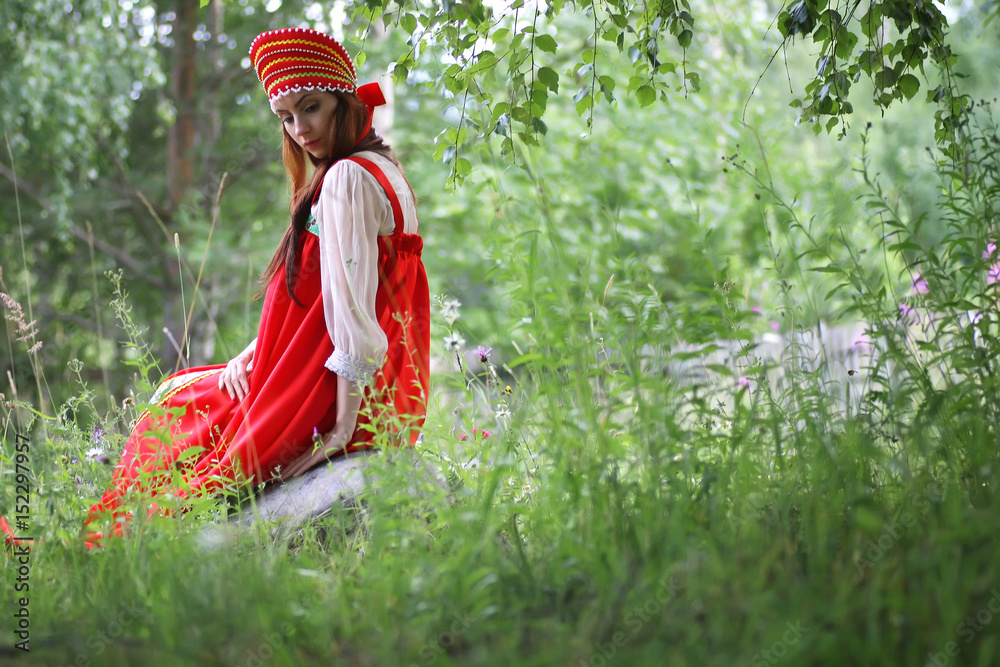 Slav in traditional dress is sitting in nature Stock Photo | Adobe Stock